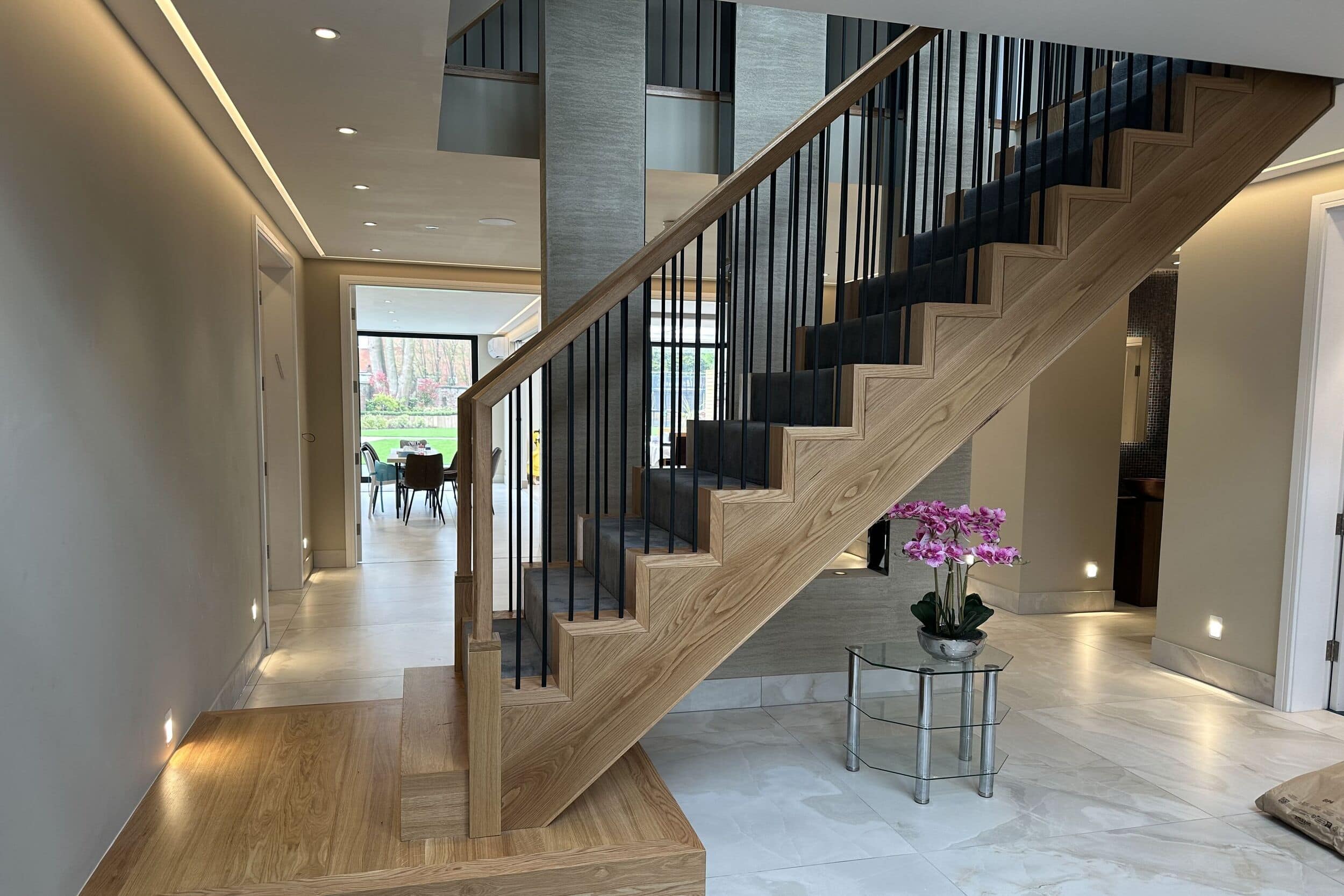 Solid Oak Cut Stringer Staircase With Round Black Iron Spindles and ...