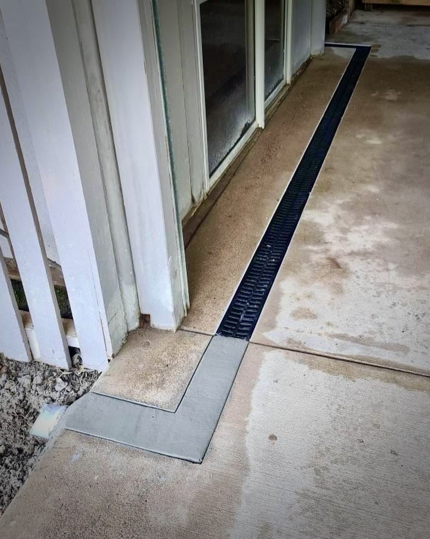 Hand Sawing for Plumbing Grate Installation